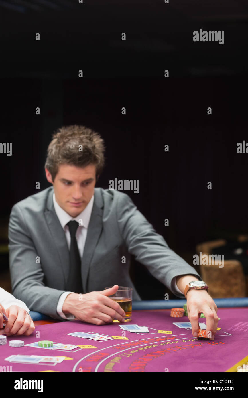 Man placing bet Stock Photo - Alamy