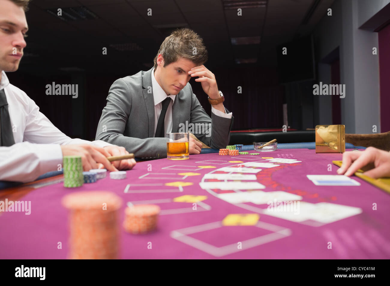 Man sitting at the table hand on his face Stock Photo - Alamy