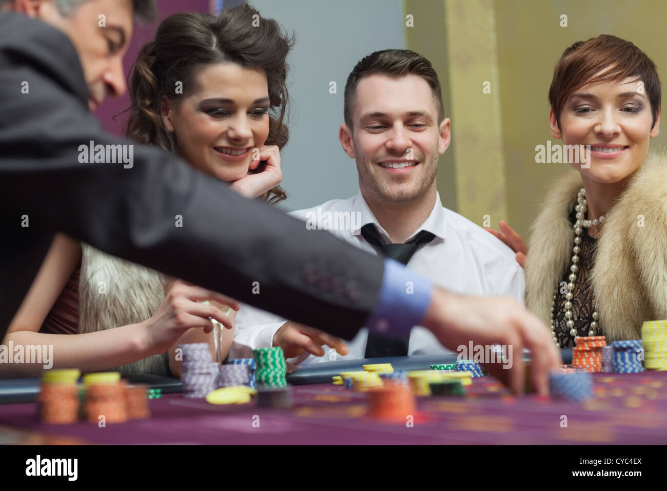 Amused group in a casino Stock Photo - Alamy