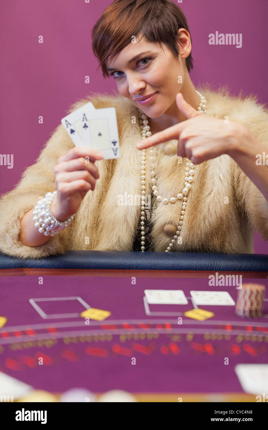 Woman in casino showing cards Stock Photo - Alamy