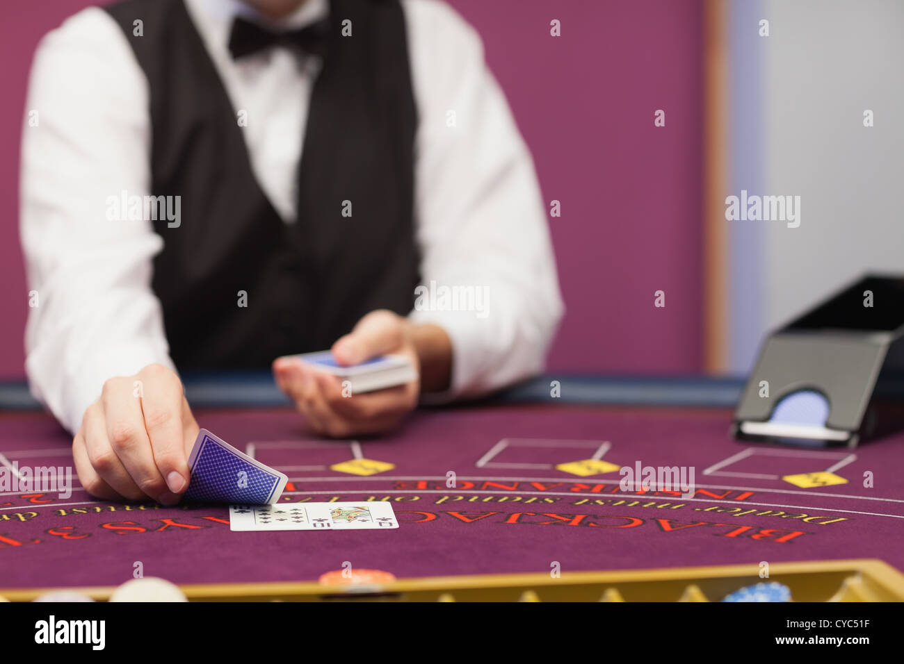 Dealer dealing cards in a casino Stock Photo - Alamy