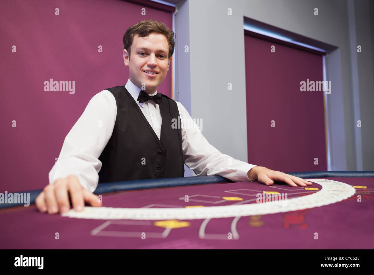 Smiling dealer with spread deck of cards Stock Photo - Alamy
