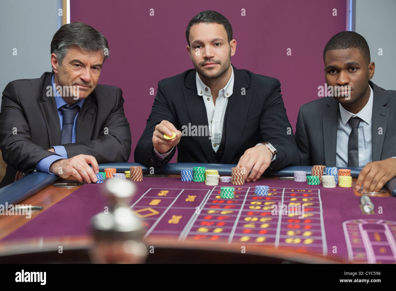 Three men playing roulette Stock Photo - Alamy