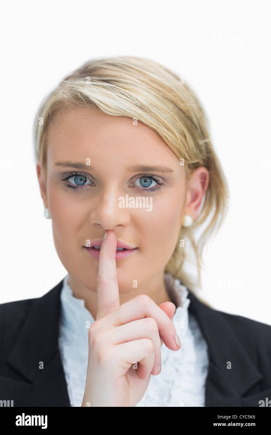Woman making quiet sign Stock Photo - Alamy