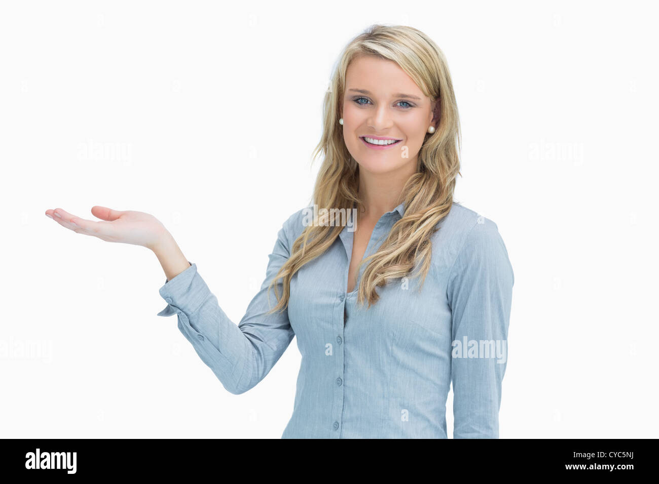 Cheerful woman presenting something Stock Photo - Alamy