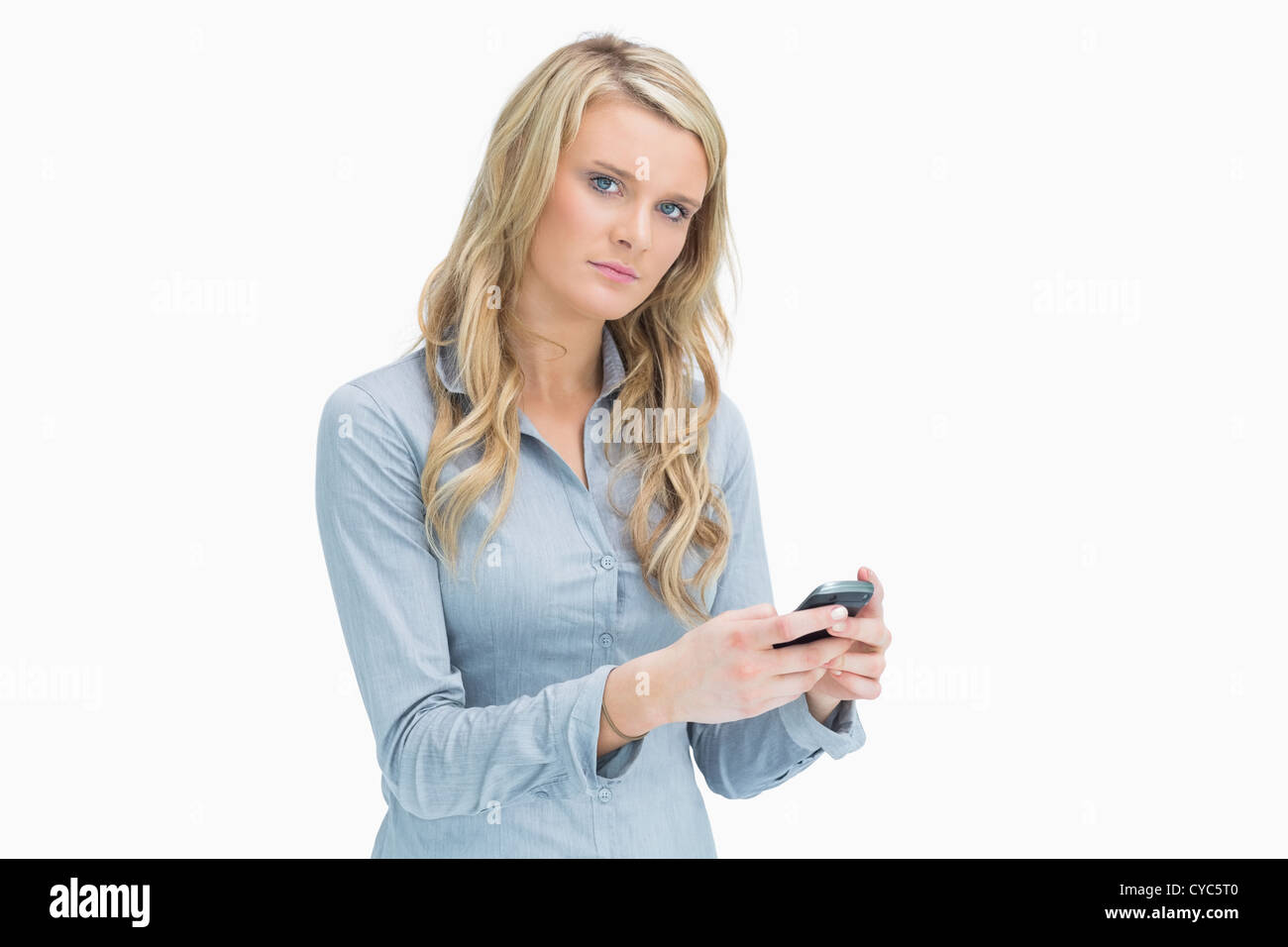 Blonde woman texting on her smartphone Stock Photo - Alamy