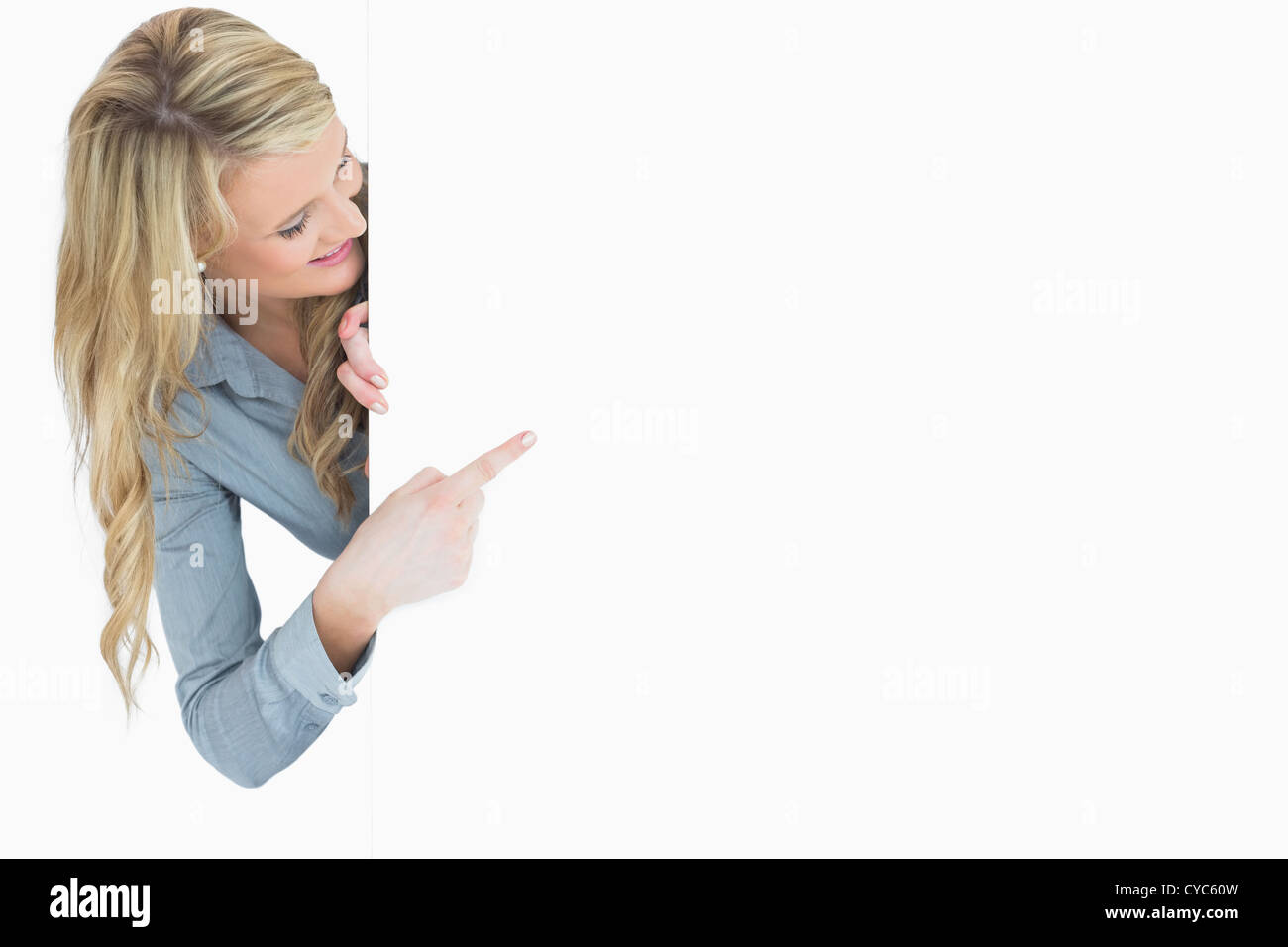 Happy woman pointing on poster Stock Photo - Alamy