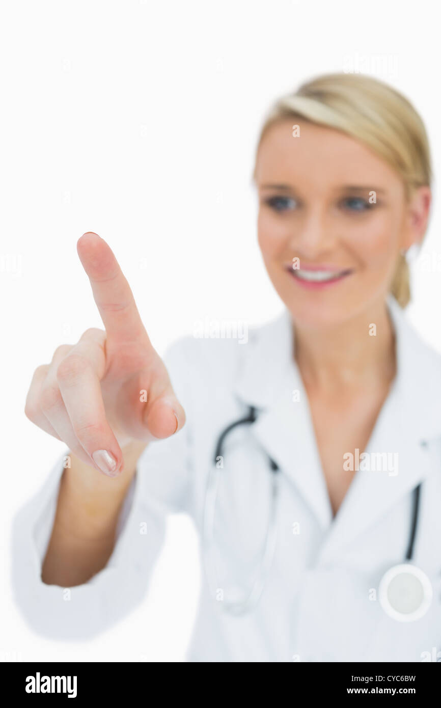 Smiling doctor touching on something Stock Photo - Alamy