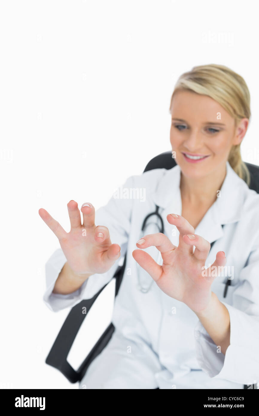 Smiling doctor touching on something Stock Photo - Alamy