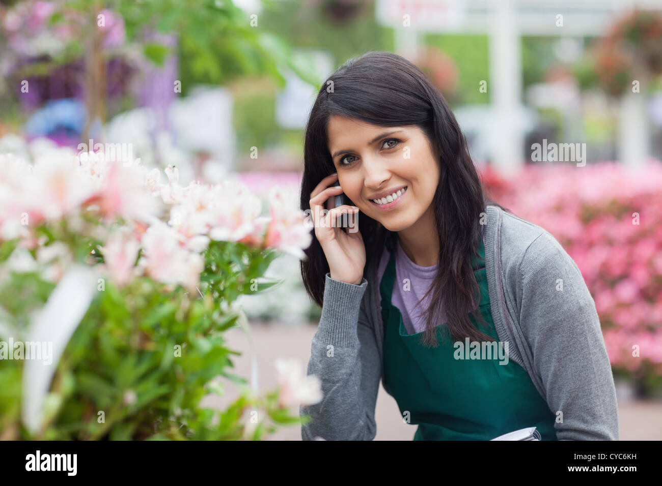 Smiling florist outside the garden centre Stock Photo - Alamy