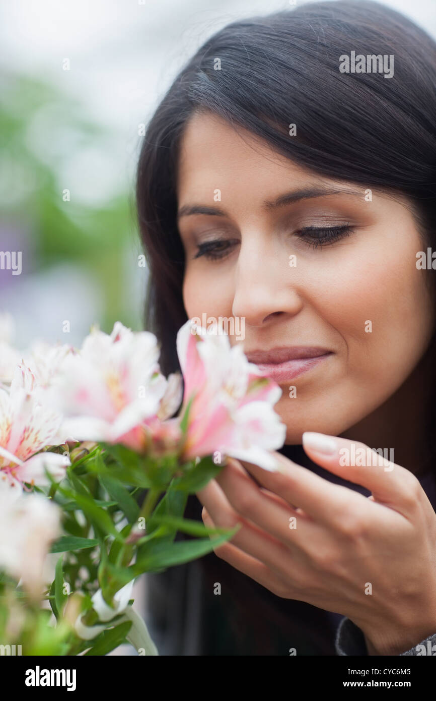 Woman smelling at the flower Stock Photo - Alamy
