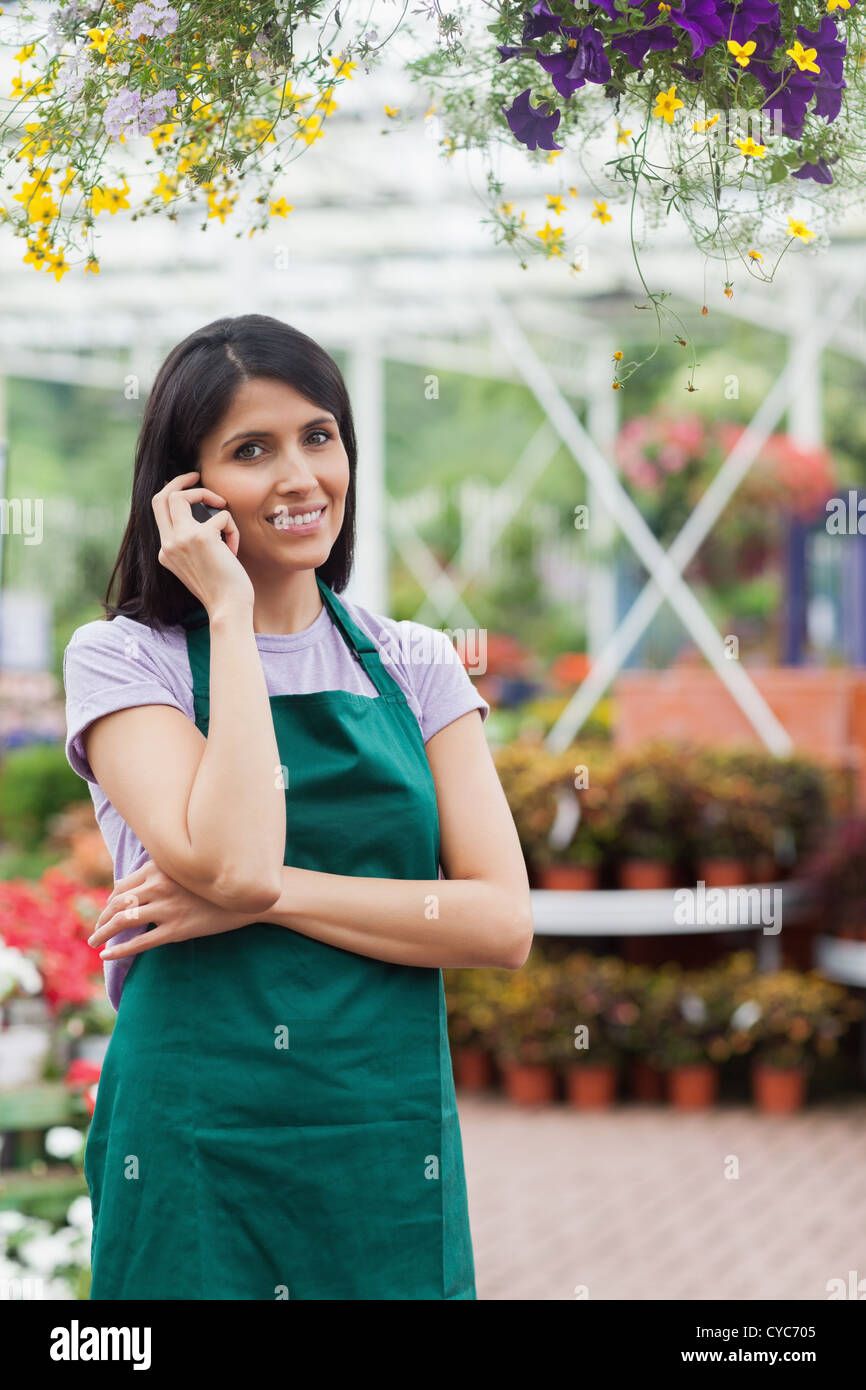 Florist doing a phone call while smiling Stock Photo - Alamy