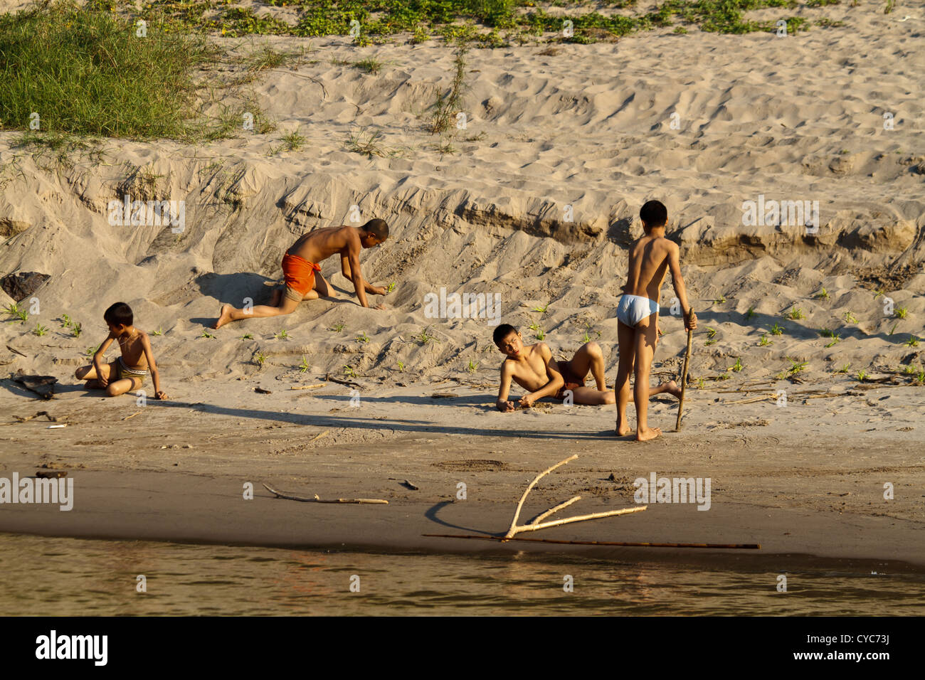 Laotian Children playing on the Banks of the River Mekong near Luang ...