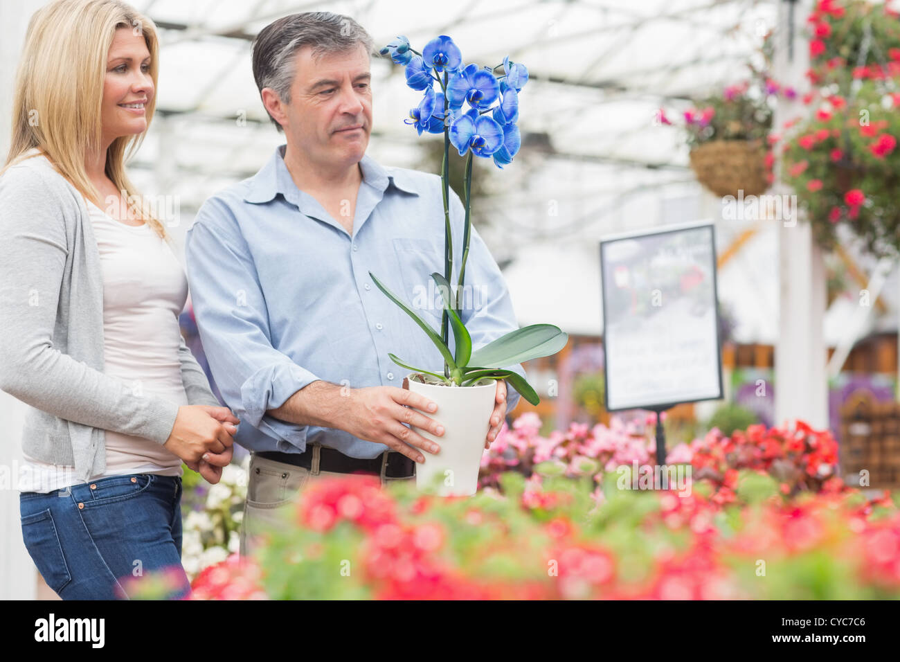 Smiling couple choosing a plant Stock Photo - Alamy