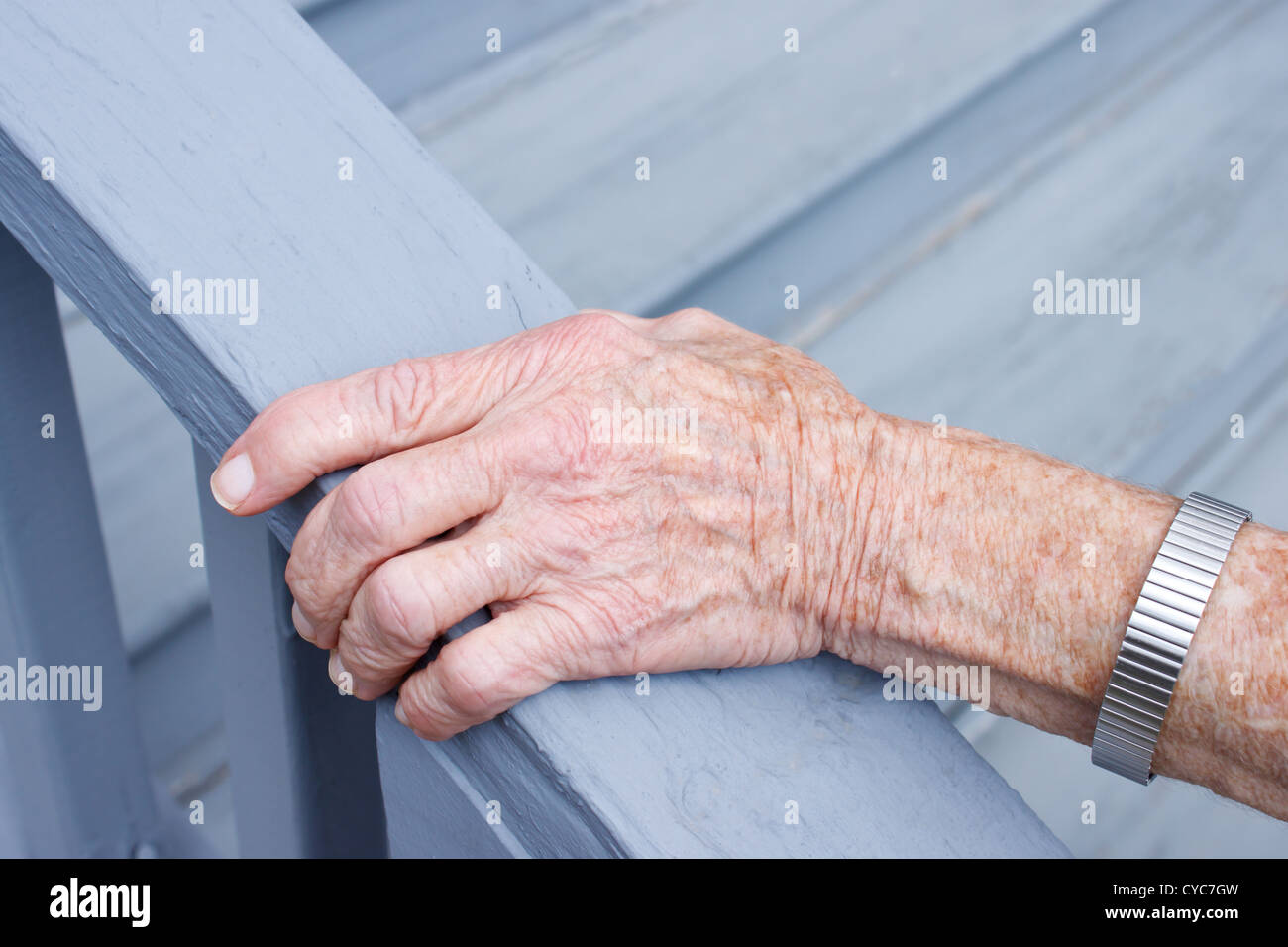 Senior woman's hand holding on to a railing Stock Photo - Alamy