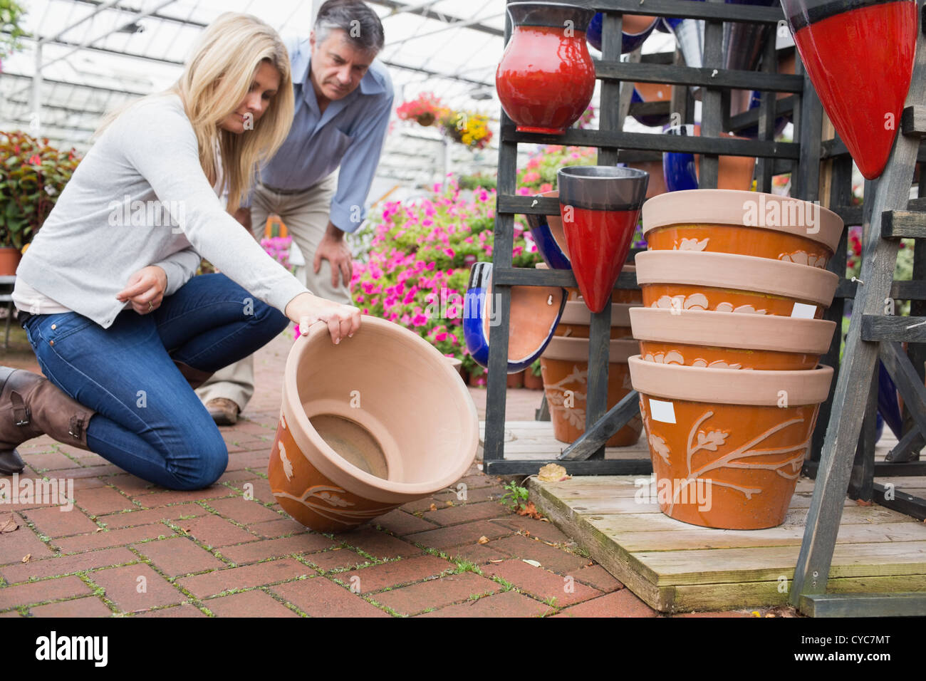 Couple looking at a pot Stock Photo - Alamy