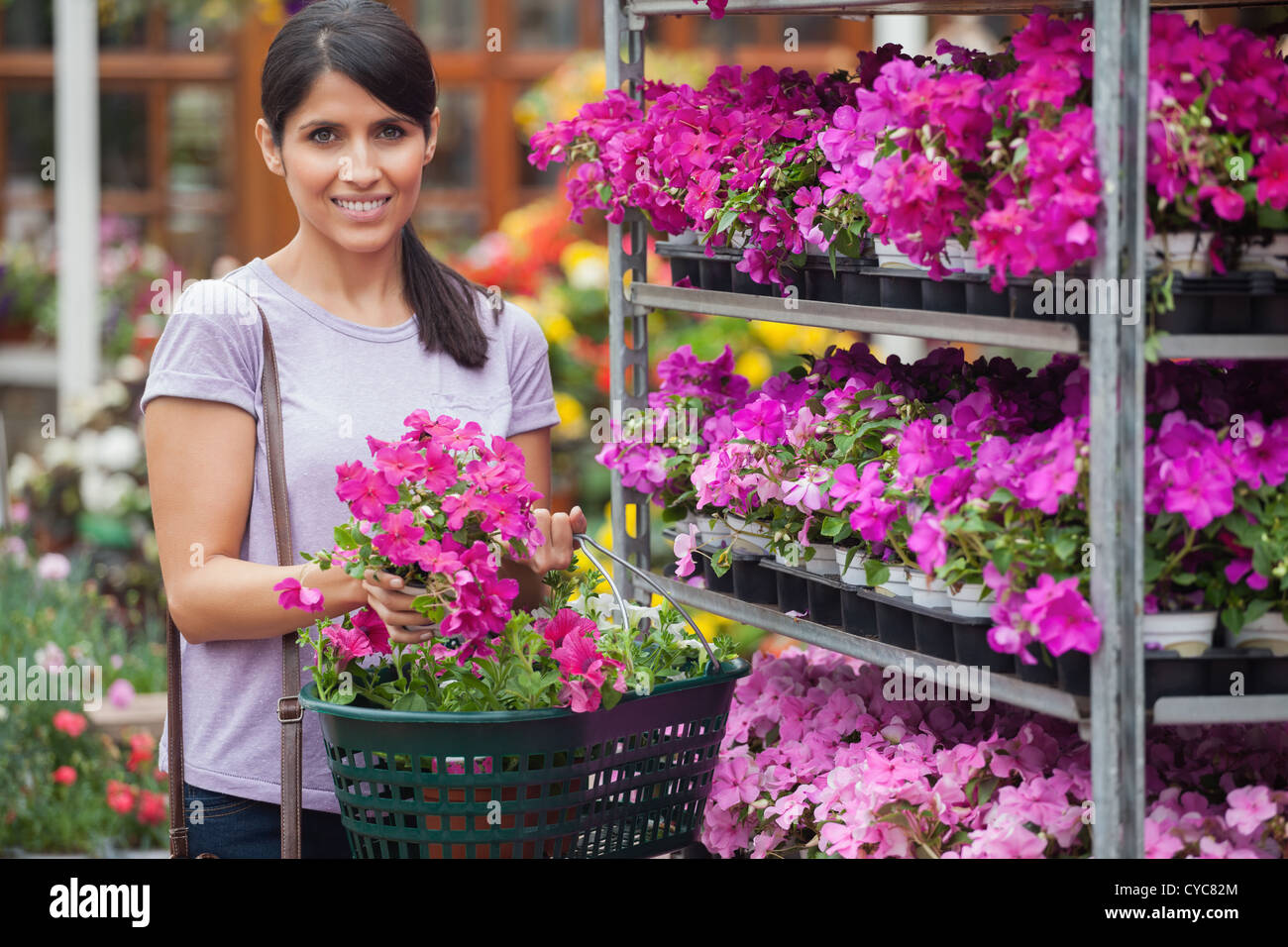 Woman carrying pot flowers hi-res stock photography and images - Alamy
