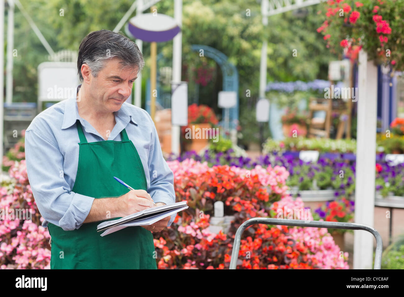 Florist taking notes Stock Photo - Alamy