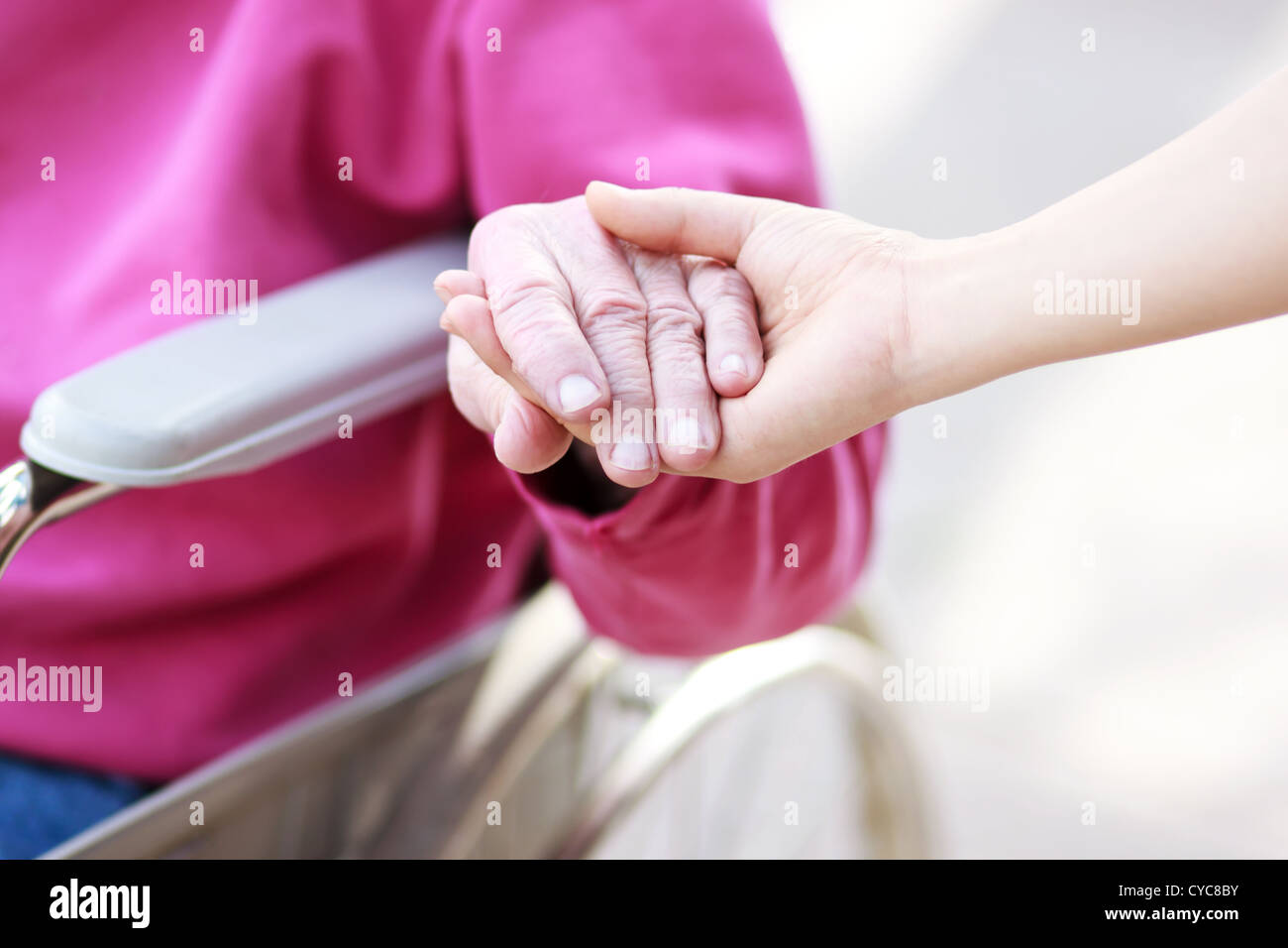 Senior Lady in Wheelchair Holding Hands with Caretaker Stock Photo - Alamy