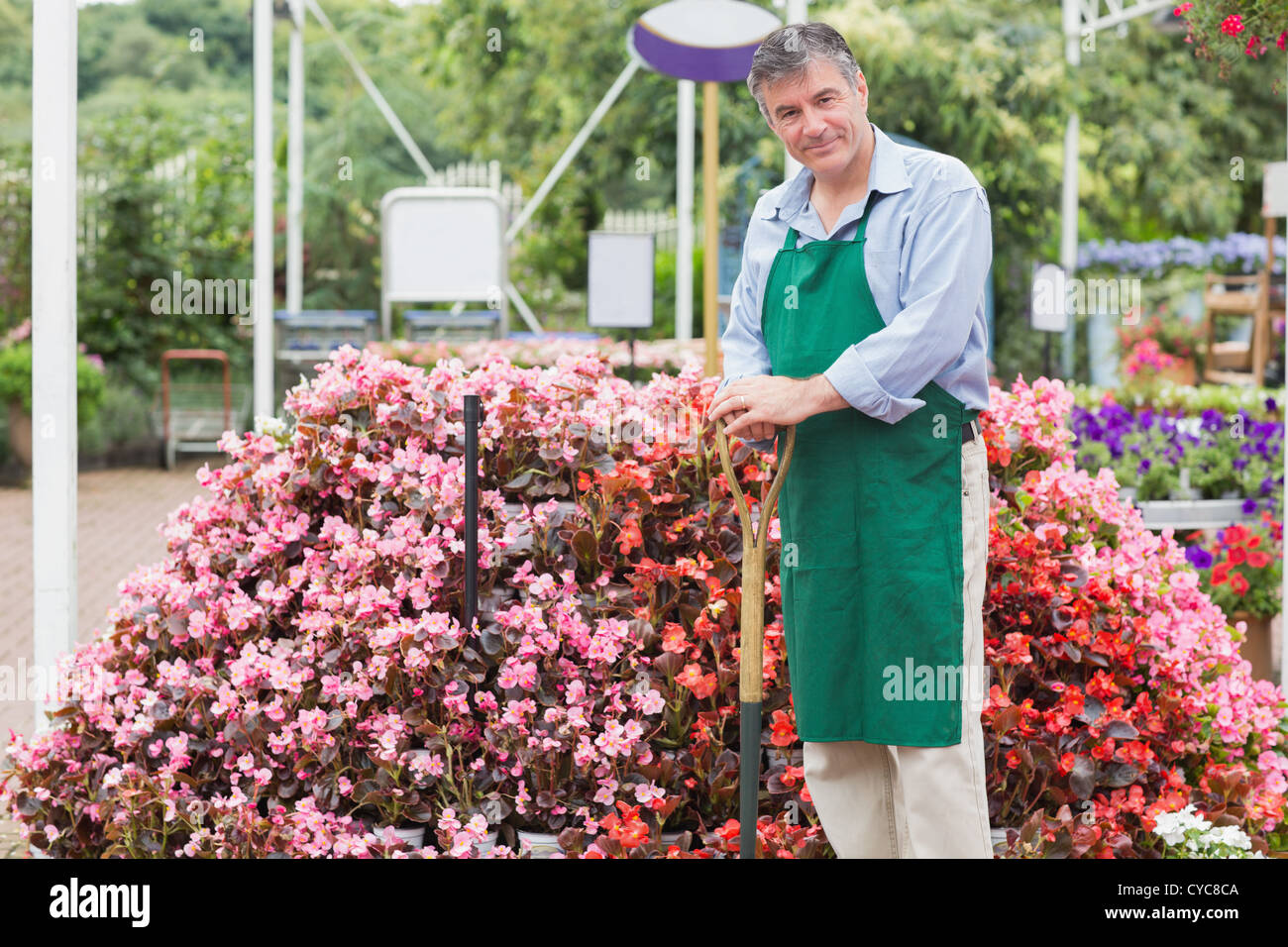 Cheerful man holding a spade Stock Photo - Alamy