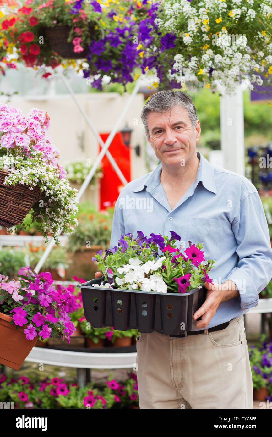 Smiling customer taking flower boxes outside Stock Photo - Alamy