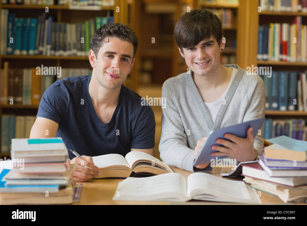 Young men looking up from studying Stock Photo - Alamy