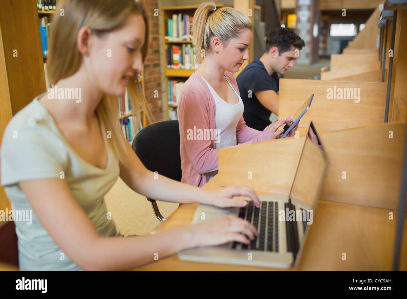 Students studying in a row Stock Photo - Alamy