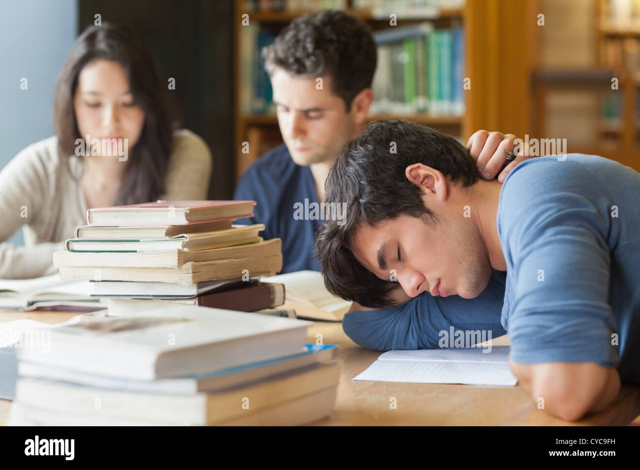 Student sleeping at study table Stock Photo - Alamy