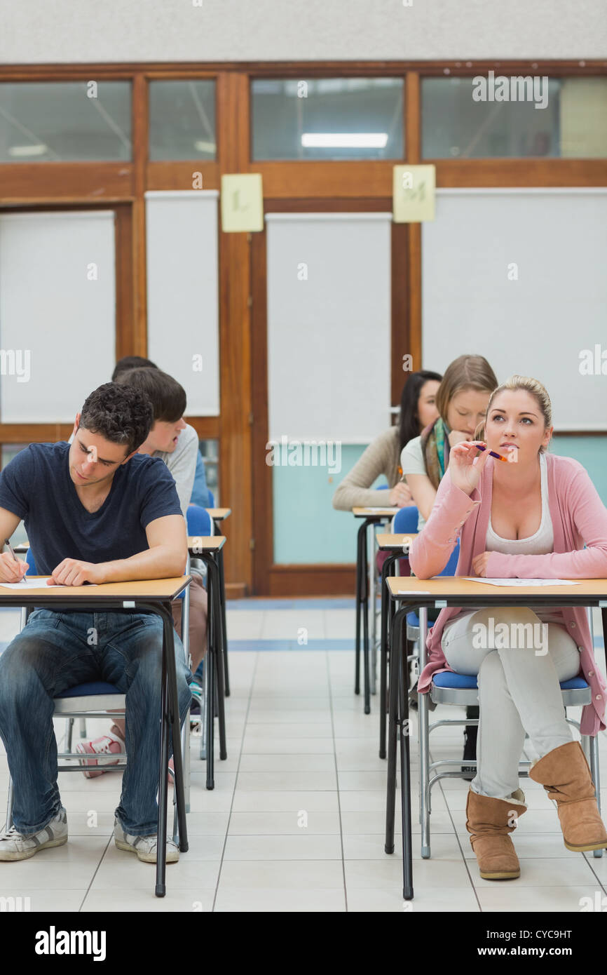 Students in an exam while one is thinking Stock Photo - Alamy