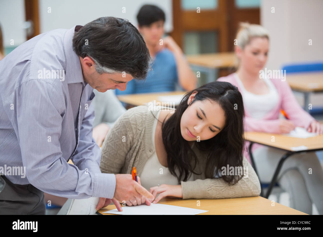 Teacher explaining something to the student Stock Photo - Alamy
