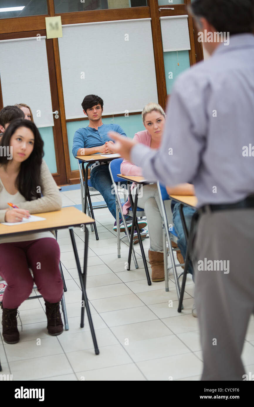 Class listening to lecturer Stock Photo - Alamy