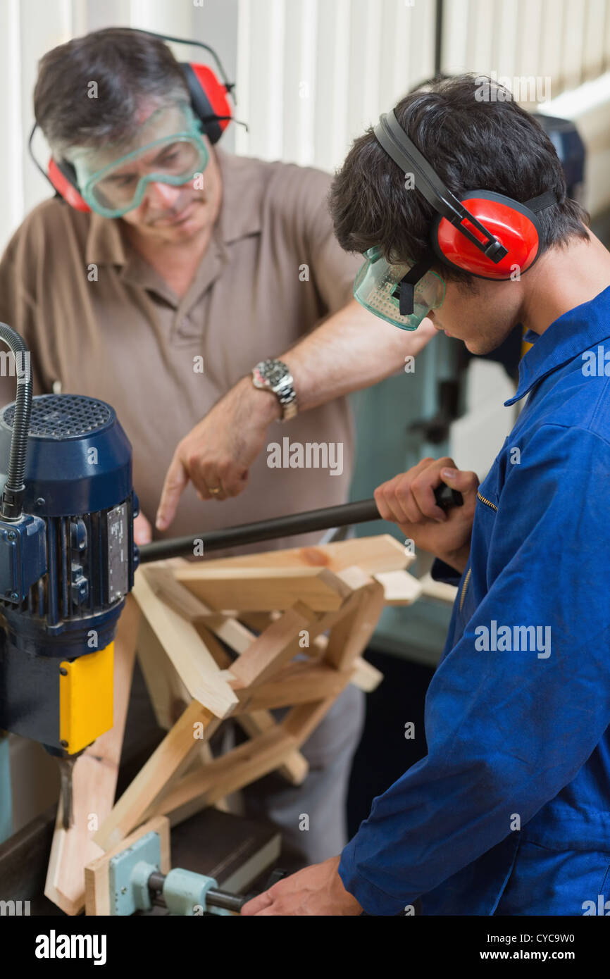 Man standing at a drilling machine Stock Photo - Alamy