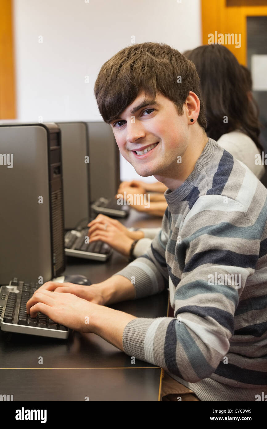 Man sitting at the computer room smiling Stock Photo - Alamy