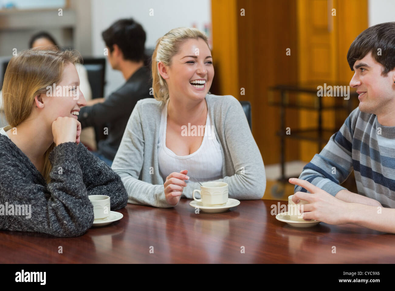 People sitting at the coffee shop smiling Stock Photo - Alamy