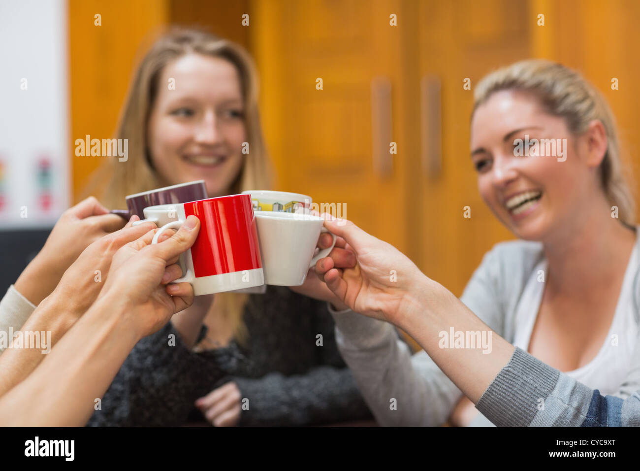 Students clinking cups Stock Photo - Alamy