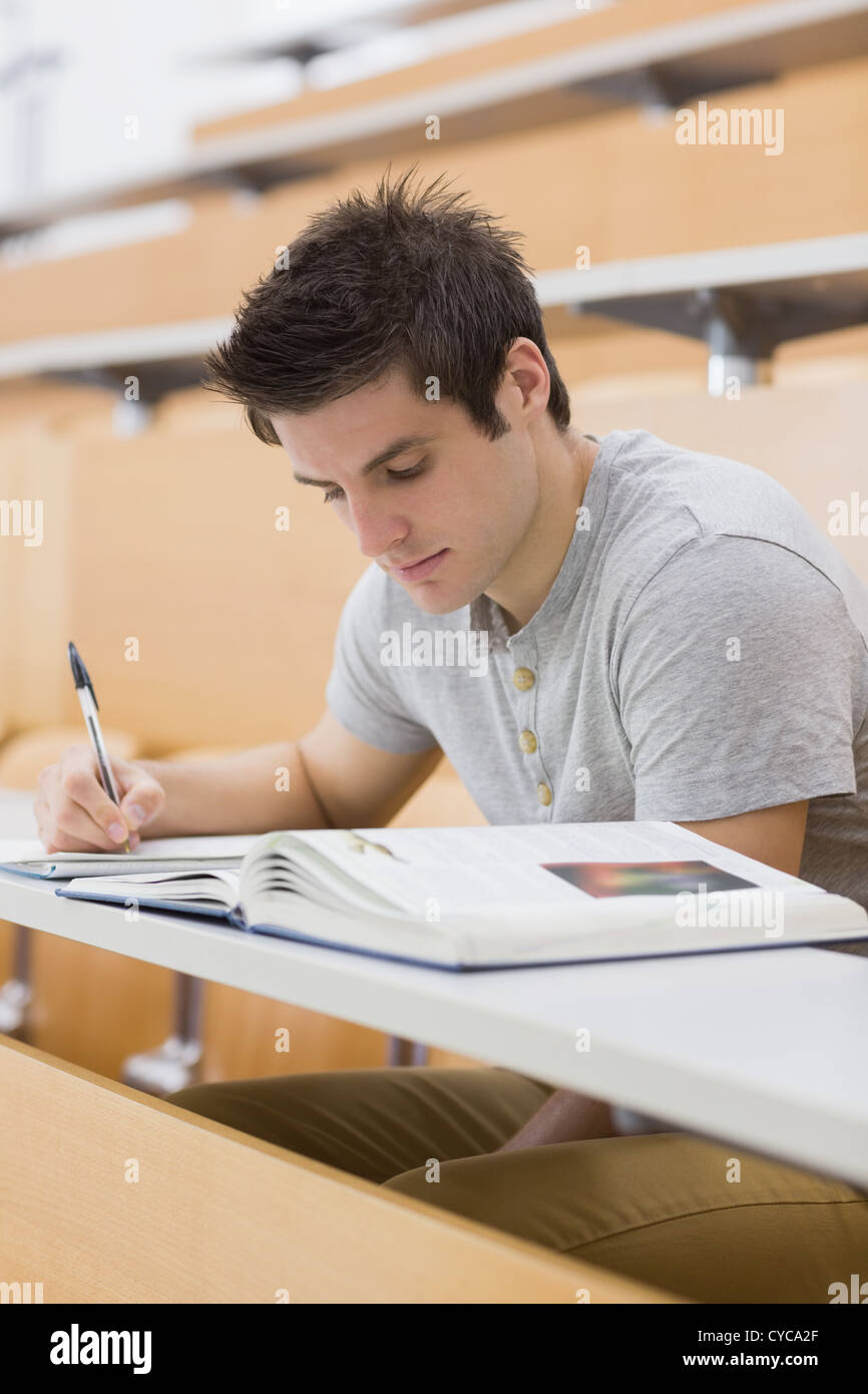 Man sitting writing Stock Photo - Alamy