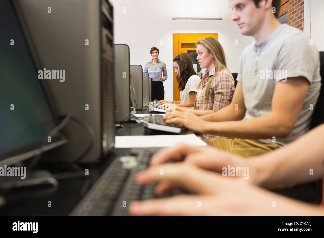 Concentrating students sitting at the computer in class Stock Photo - Alamy