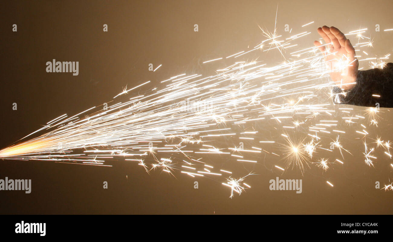 A person's hand and fireworks Stock Photo - Alamy