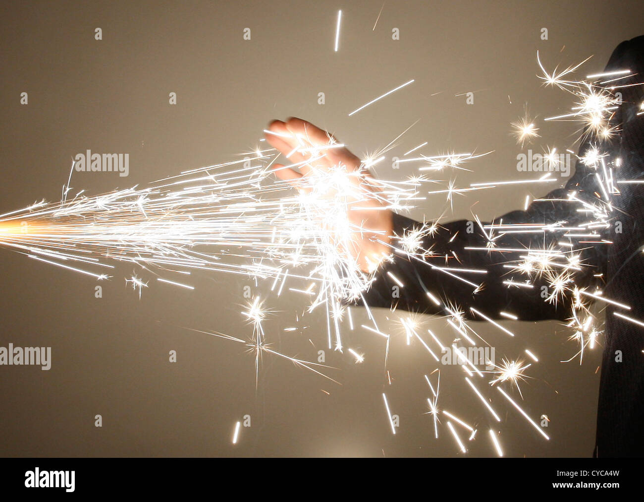 A person's hand and fireworks Stock Photo - Alamy