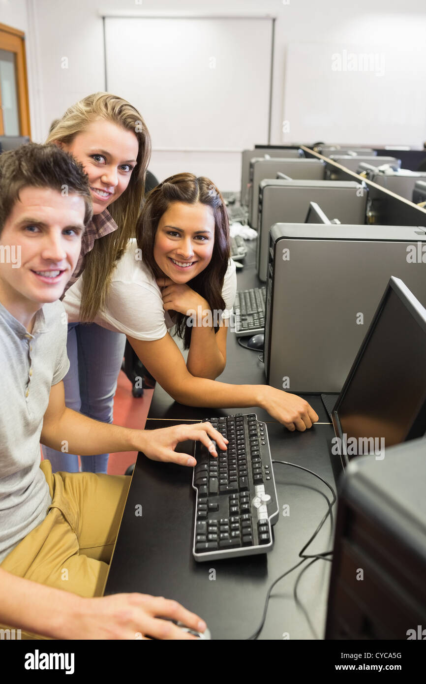 Students sitting at the computer room smiling Stock Photo - Alamy