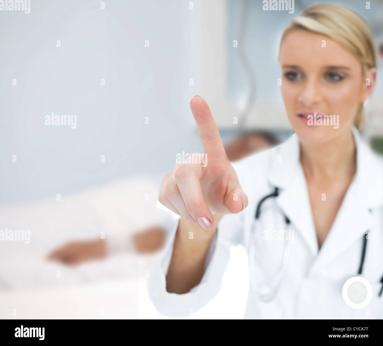 Nurse standing pressing on something Stock Photo - Alamy