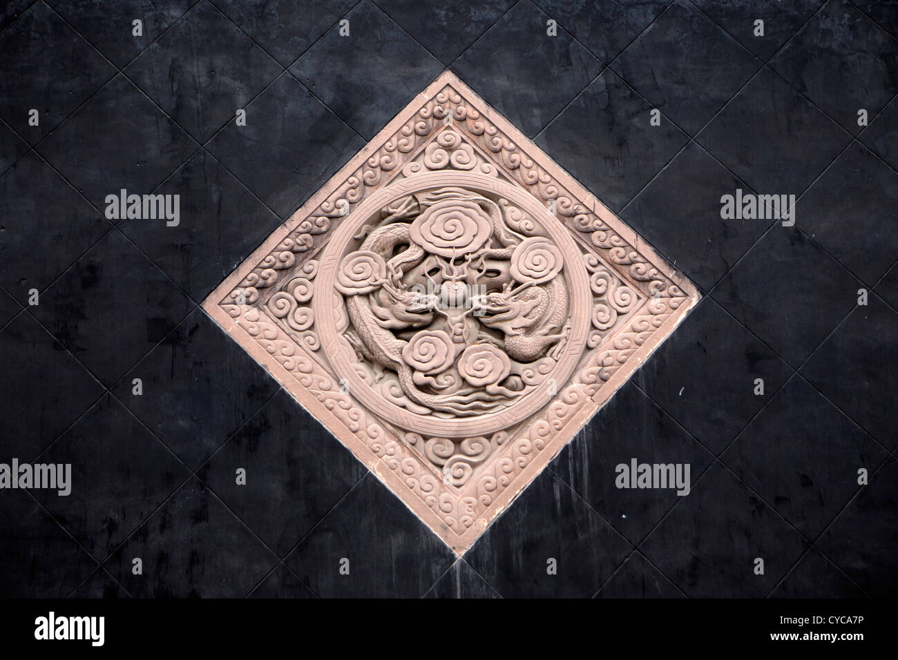Chinese dragon sculpture on the black brick wall Stock Photo - Alamy