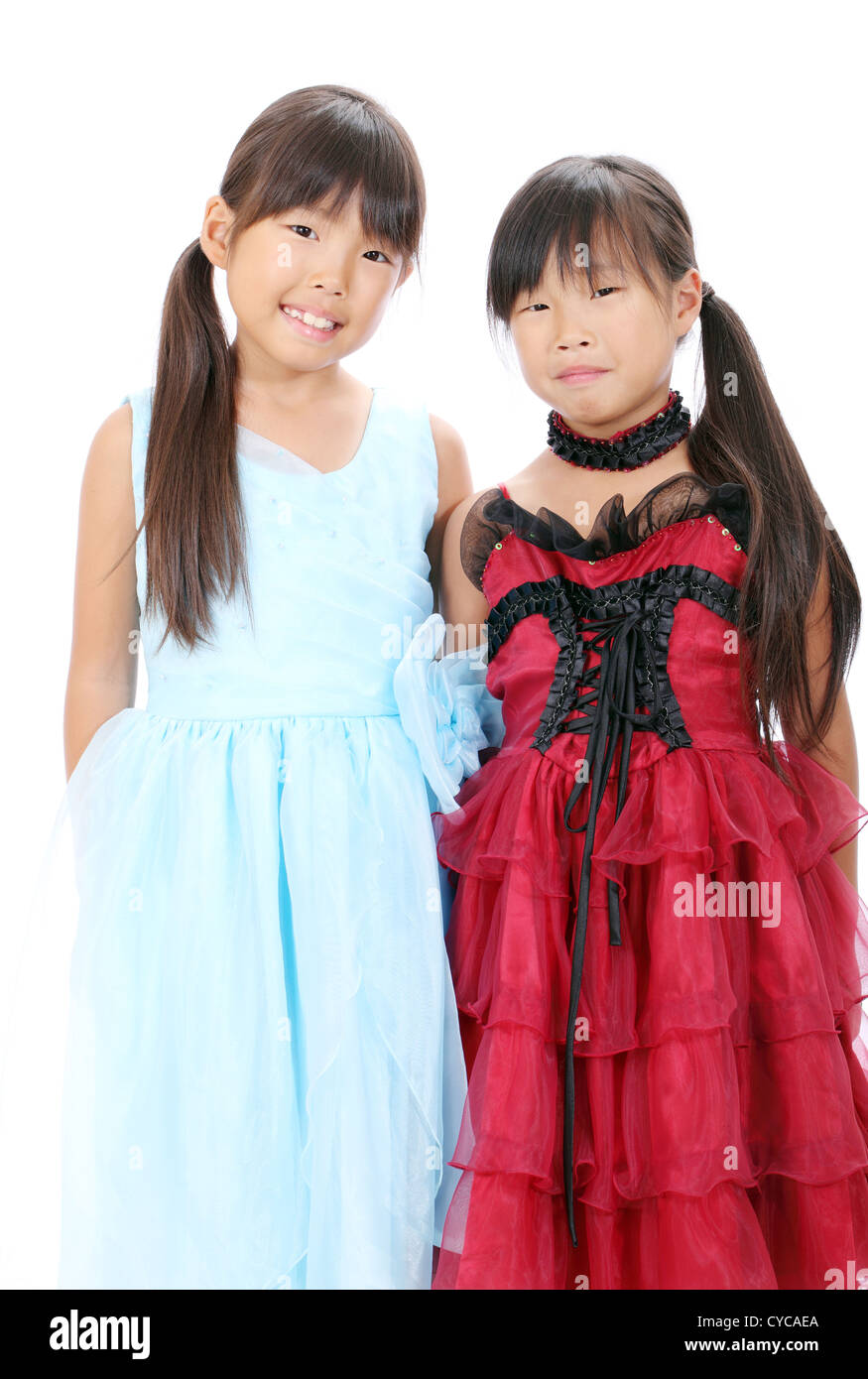 Two little asian girls wearing dress on white background Stock Photo ...
