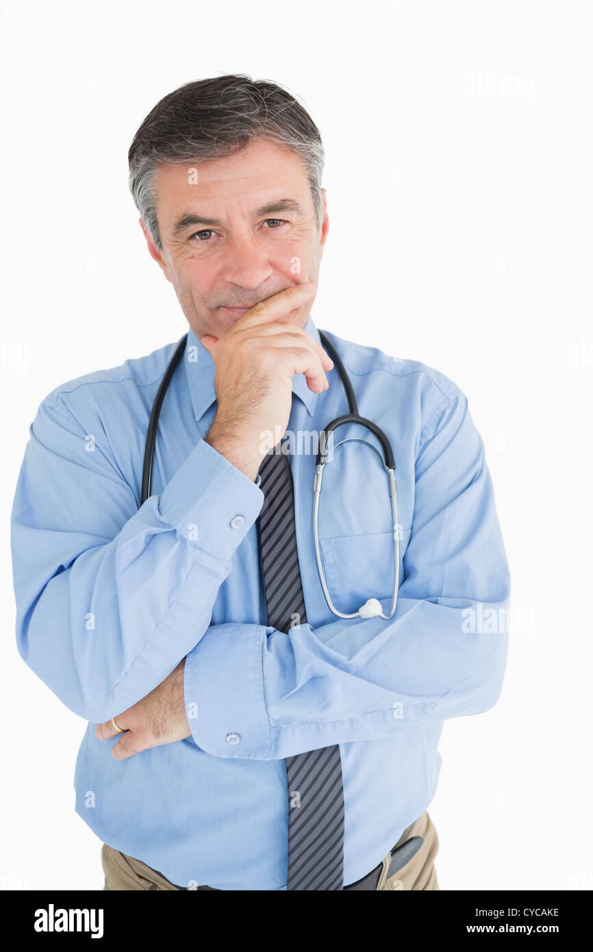 Smiling doctor is thinking Stock Photo - Alamy