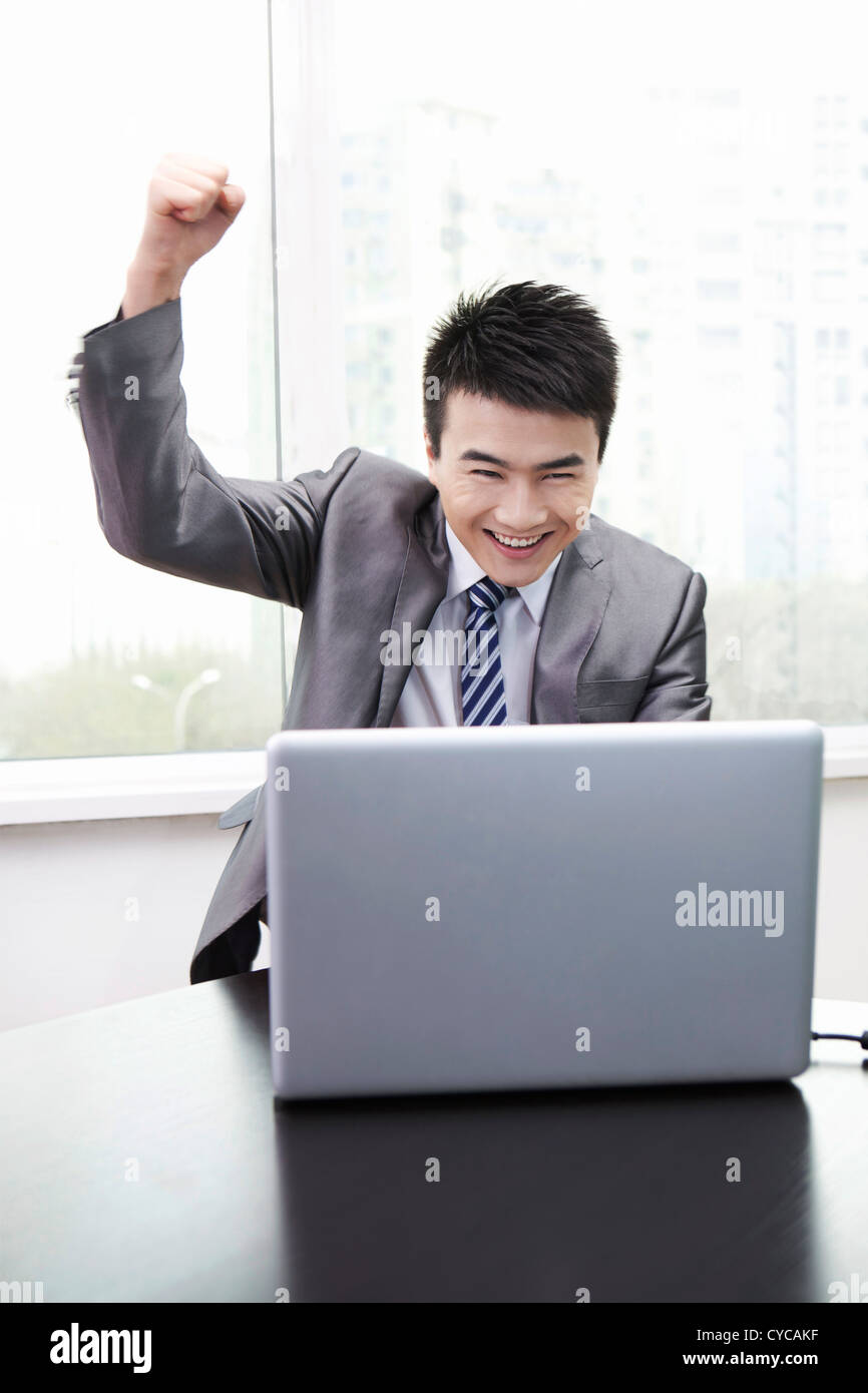 Businessman using laptop in office Stock Photo - Alamy