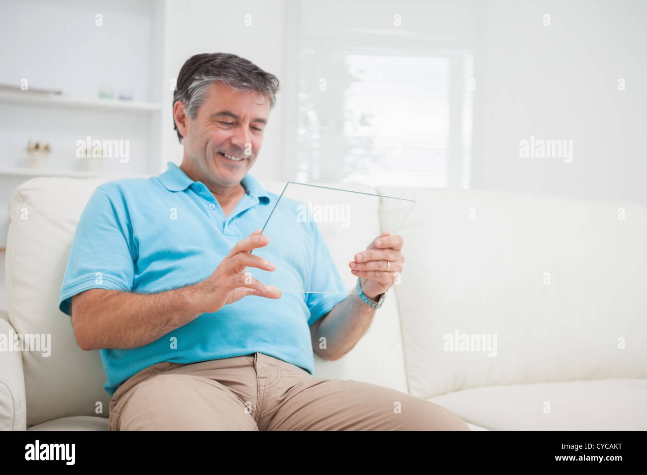 Smiling man holding an clear pane Stock Photo - Alamy