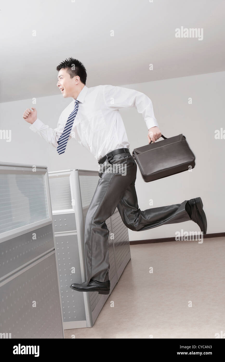 Businessman running with briefcase,side view Stock Photo - Alamy