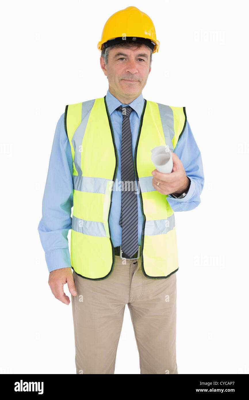 Architect in vest and helmet holding a plan Stock Photo - Alamy