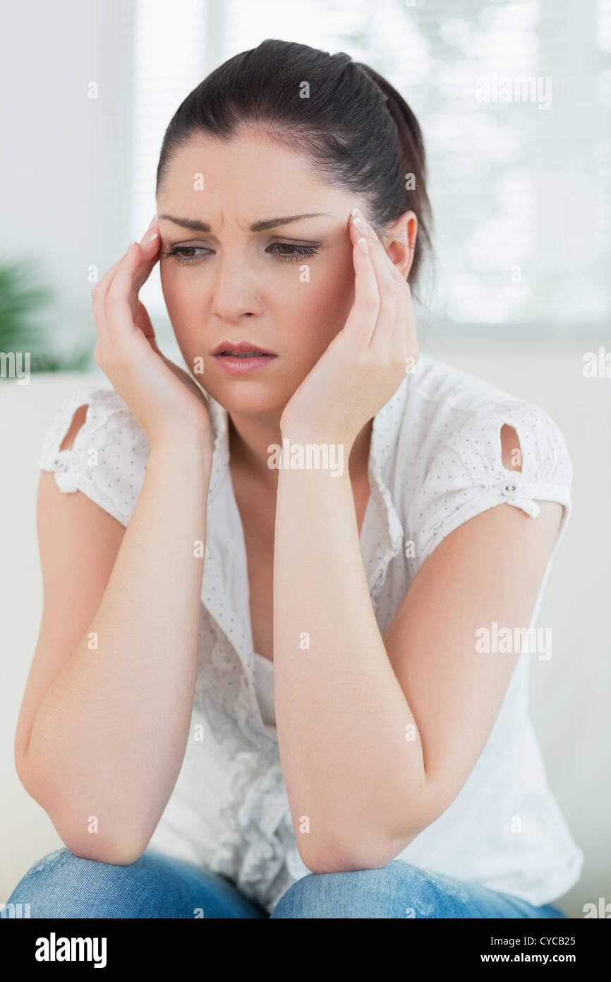 Stressed woman sitting on the couch Stock Photo - Alamy