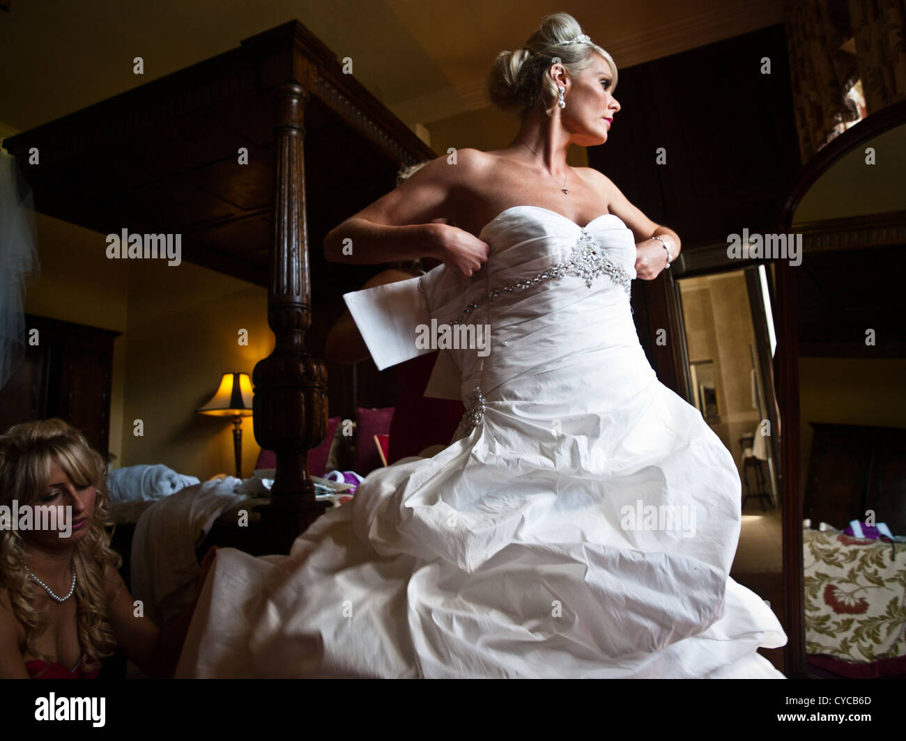 A Bride gets into her wedding dress on her wedding day Stock Photo - Alamy